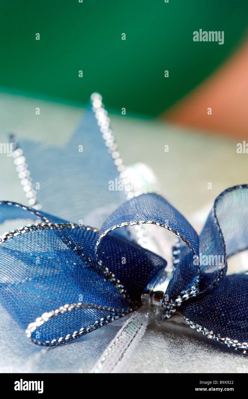 Wrapped gift with blue ribbon bow Stock Photo - Alamy