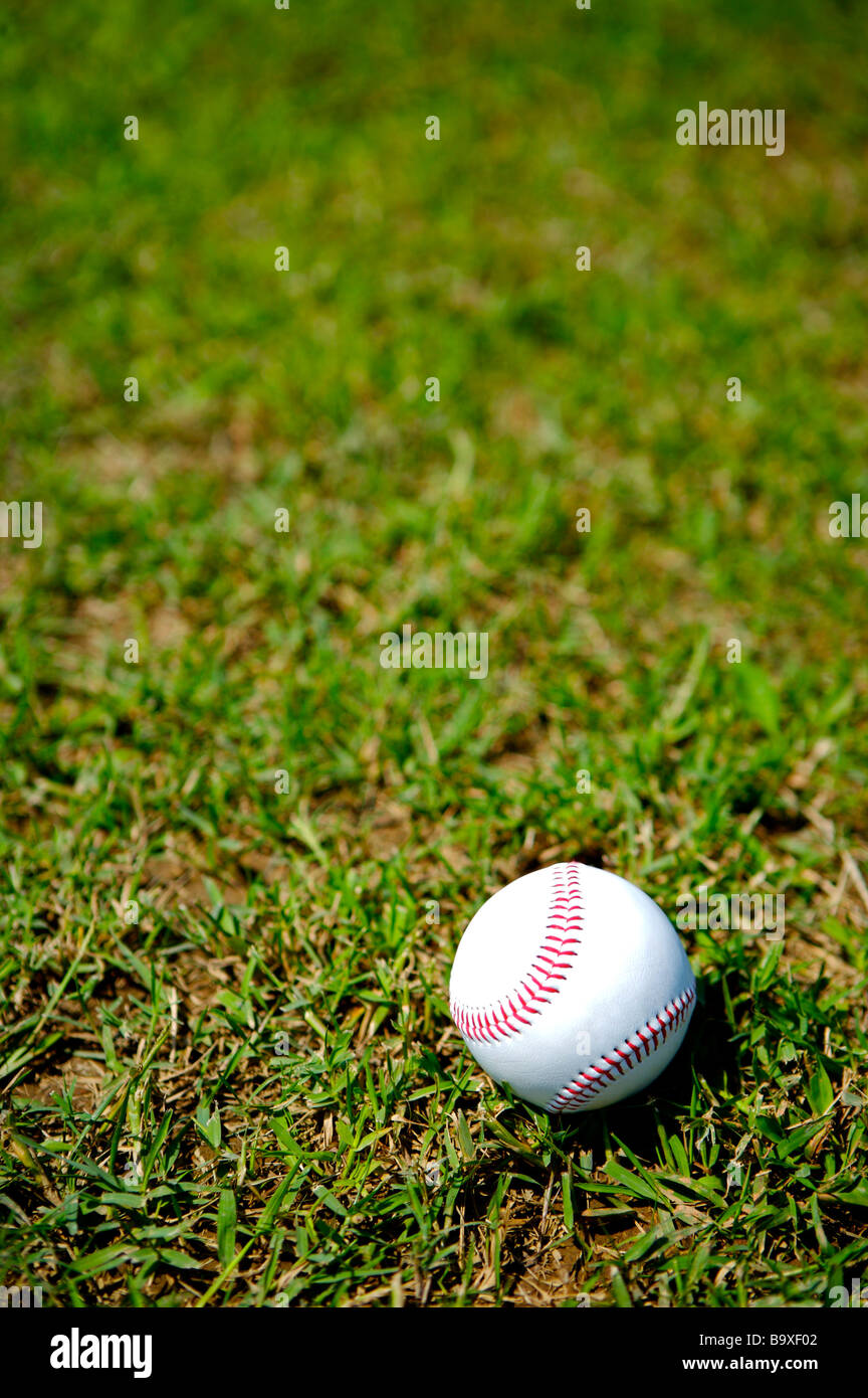 Baseball on grass Stock Photo - Alamy