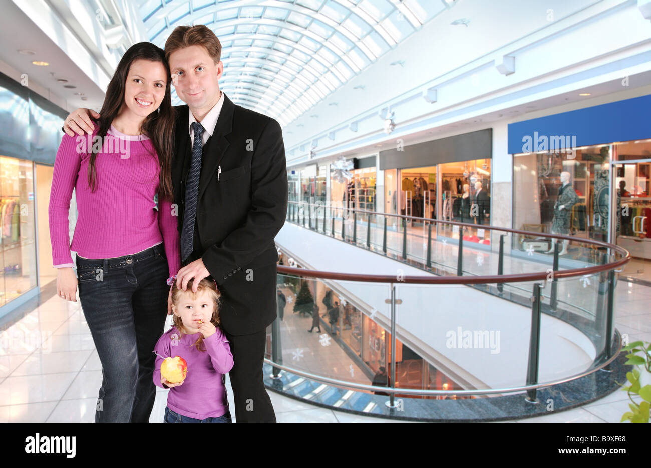 family with girl in universal store Stock Photo - Alamy