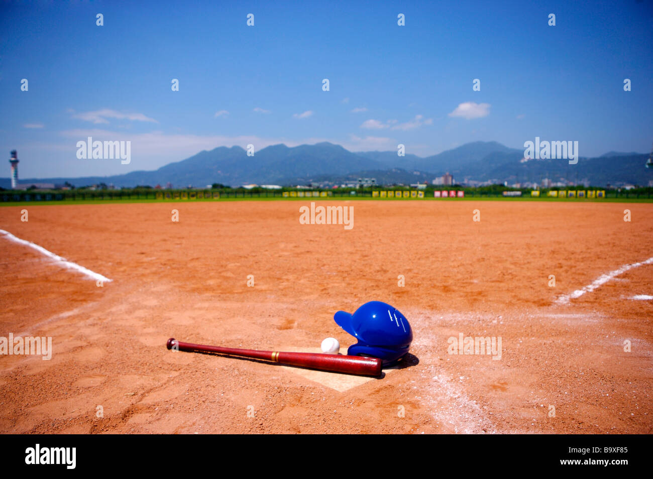Baseball helmet bat and ball on home base Stock Photo - Alamy