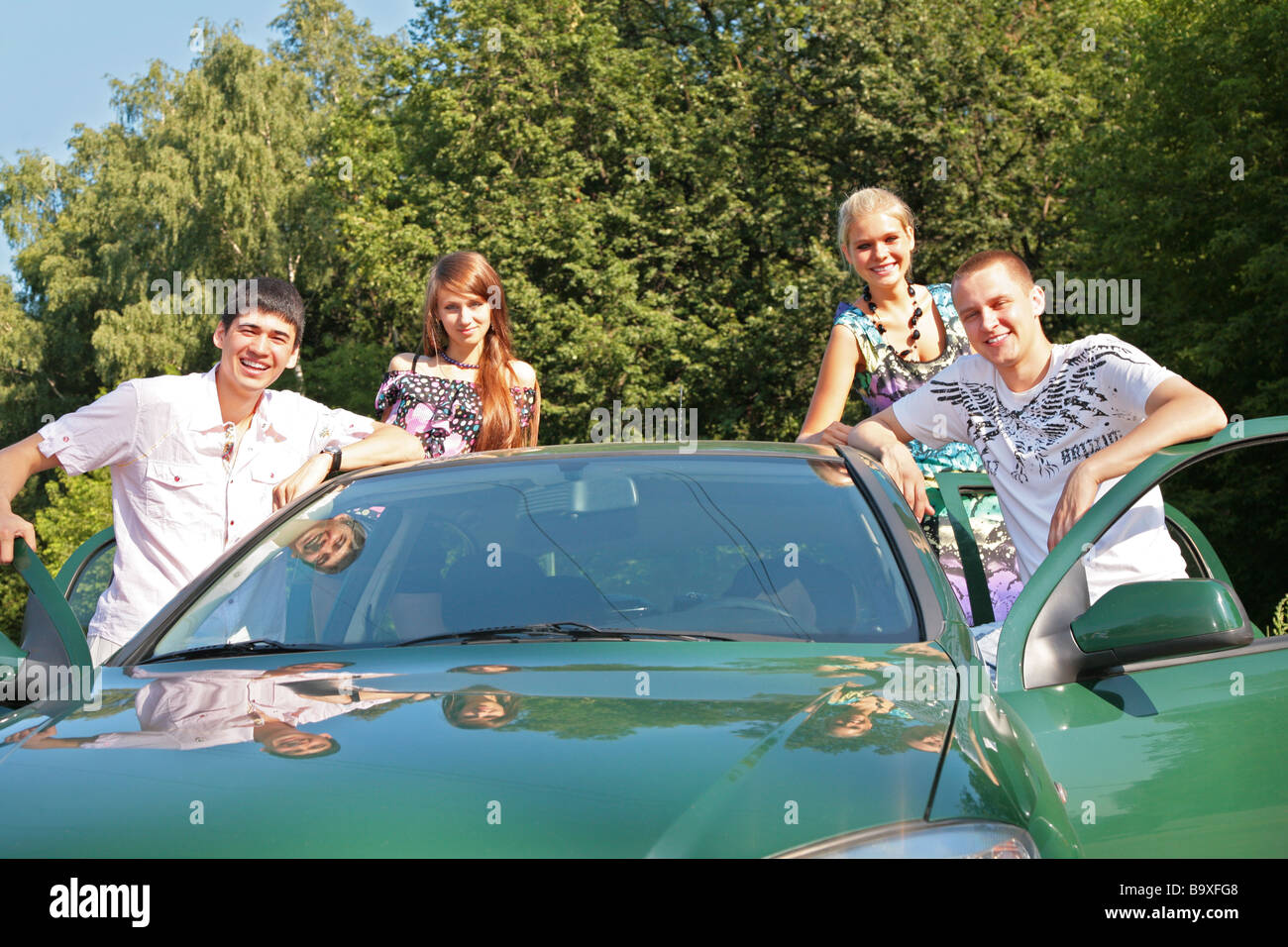 Group of friends with car outdoor Stock Photo - Alamy