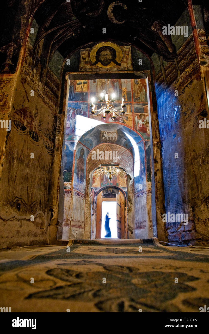 Interior of one of the monasteries of Bucovina and silhouette of a nun ...