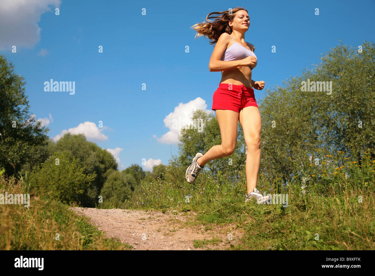 Girl running in forest Stock Photo - Alamy