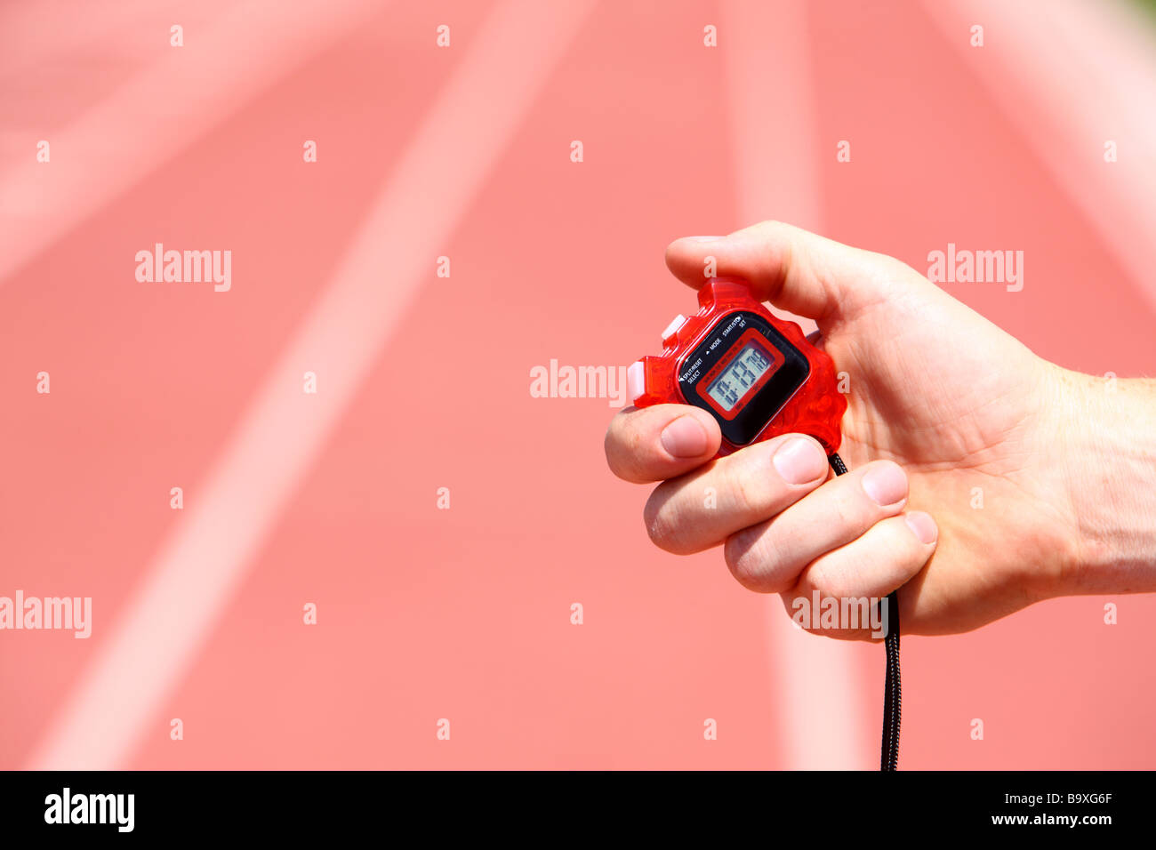 Stopwatch with track background Stock Photo - Alamy
