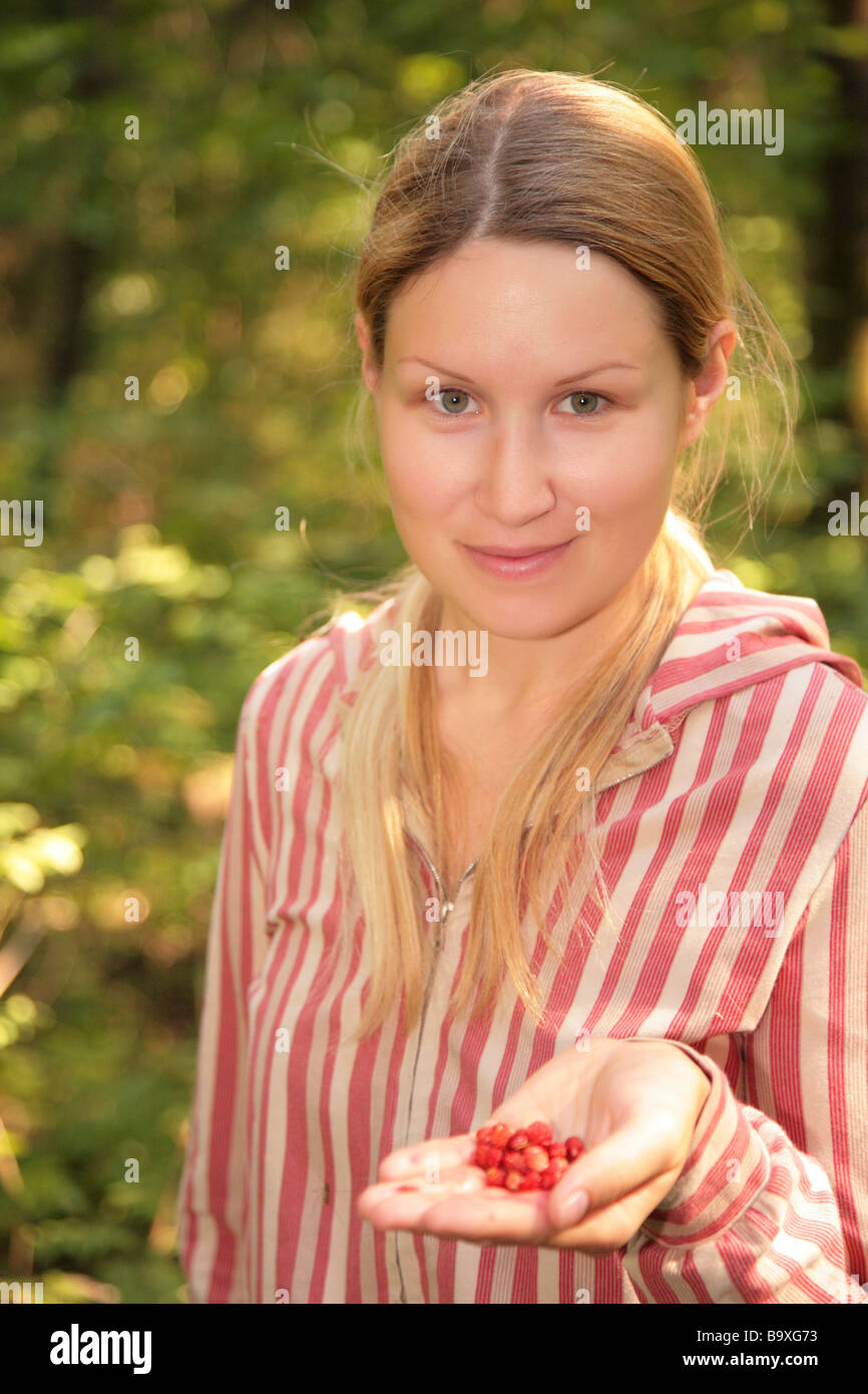 Girl with wood berries on palm Stock Photo - Alamy