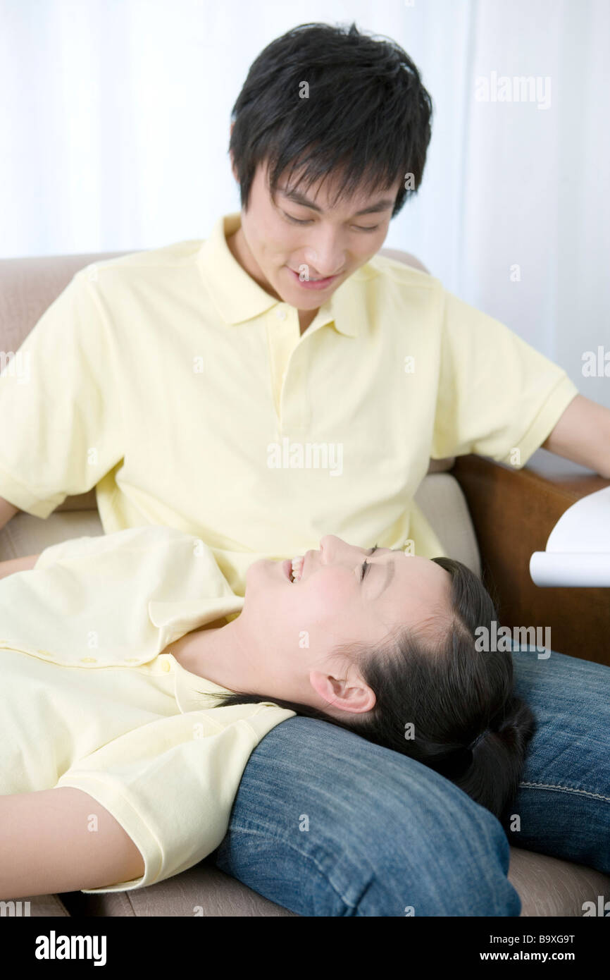 Young woman lying on man s lap smiling Stock Photo - Alamy