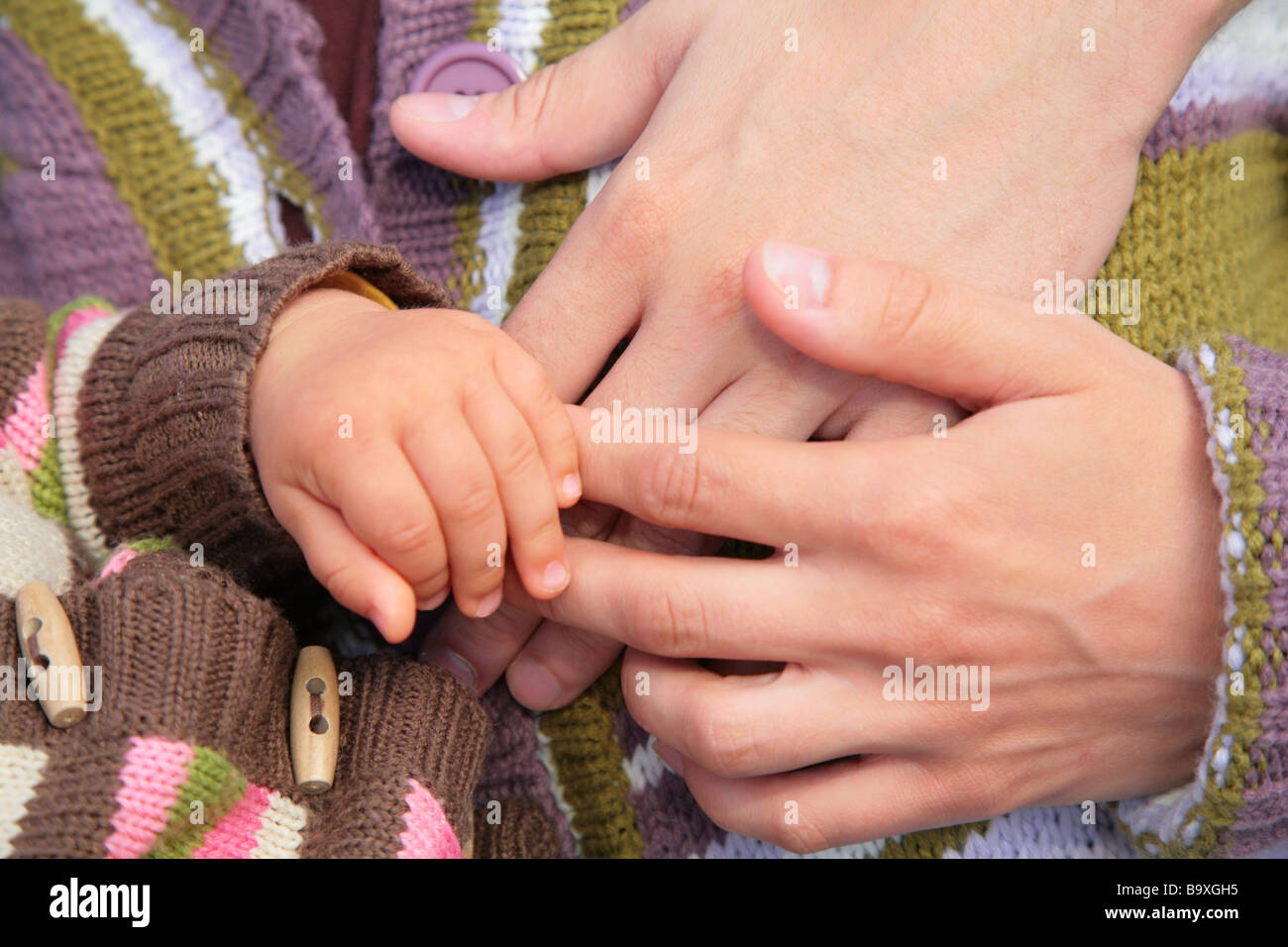 Hands of parents and child Stock Photo - Alamy