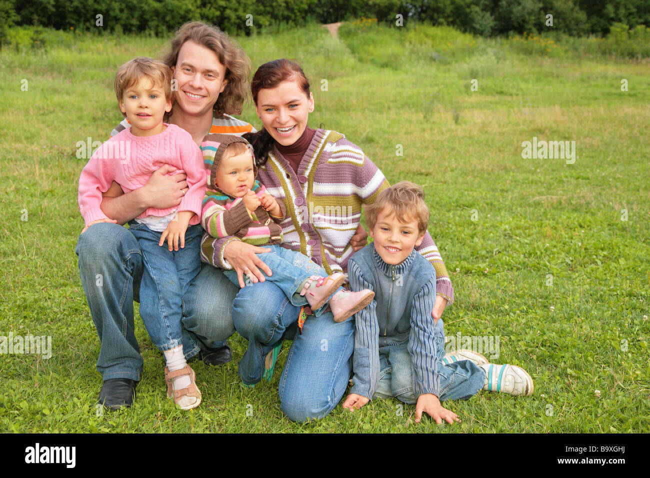 Family of five portrait on grass Stock Photo - Alamy