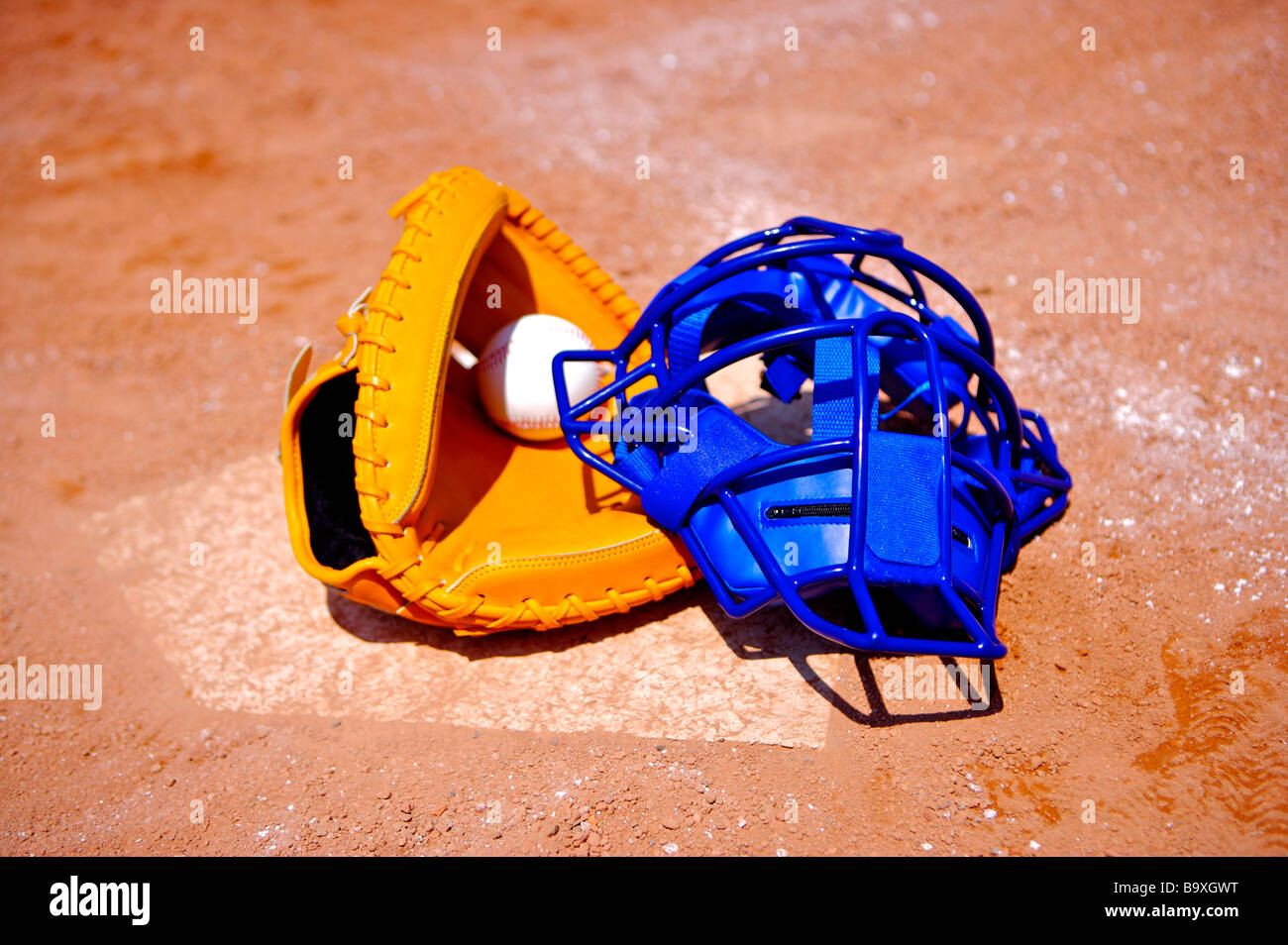 Baseball glove cap and ball on home base Stock Photo - Alamy