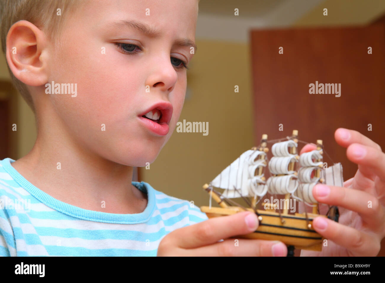Boy with toy sail boat hi-res stock photography and images - Alamy