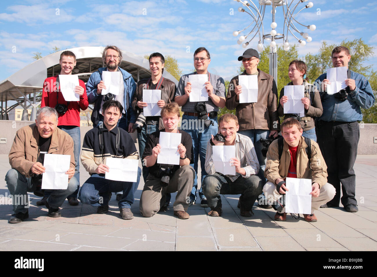 Group of people photographers with sheets of paper Stock Photo - Alamy