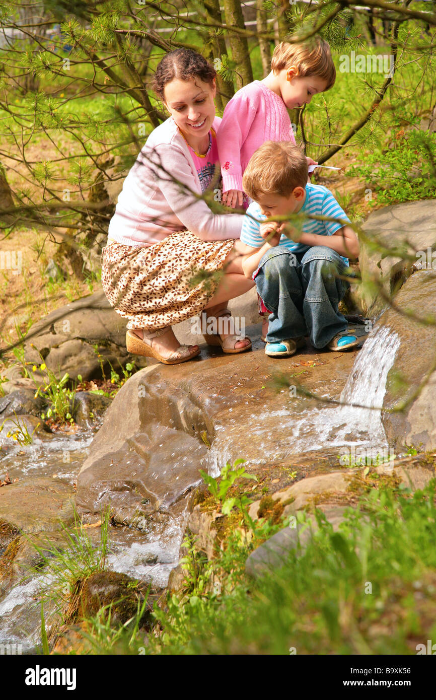 mother with children look on little waterfall Stock Photo - Alamy