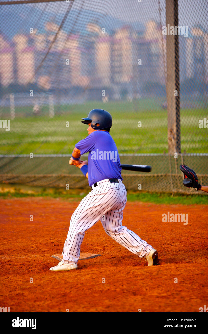 Baseball player swinging bat Stock Photo - Alamy