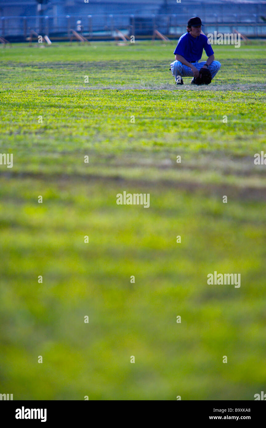 Player crouching on grass Stock Photo - Alamy