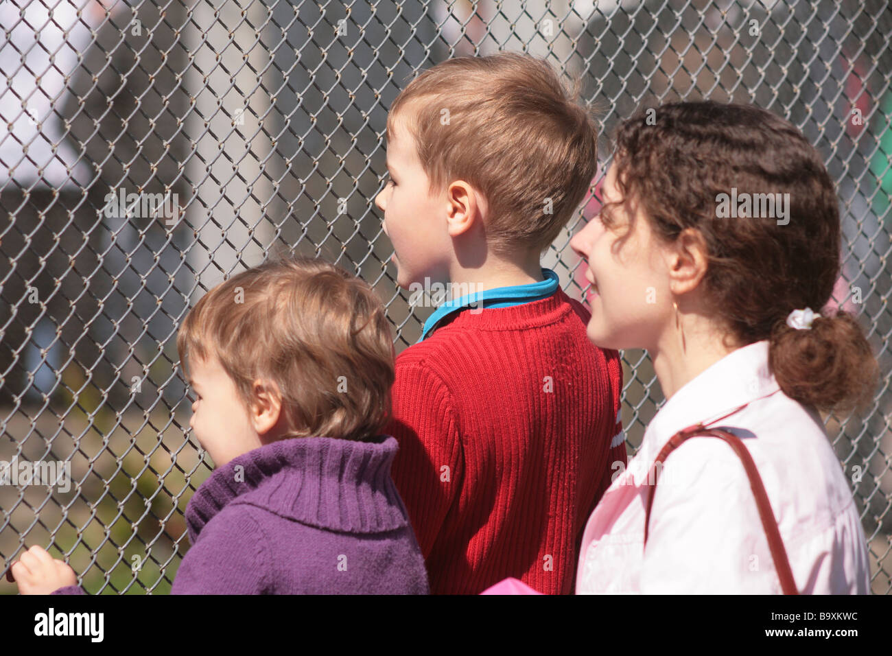 Mother and children look through lattice Stock Photo - Alamy