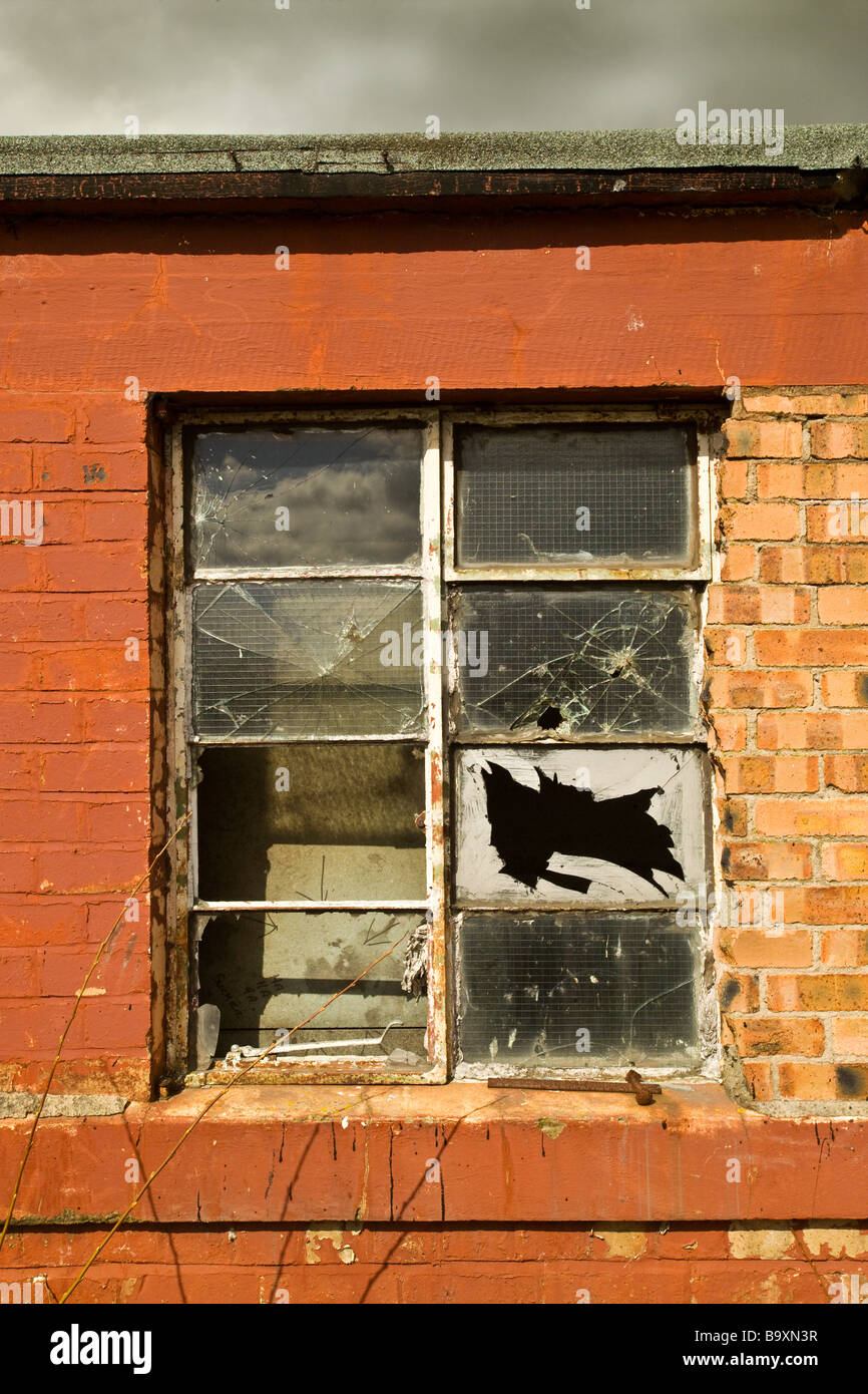 photograph of smashed windows in abandonded building Stock Photo - Alamy