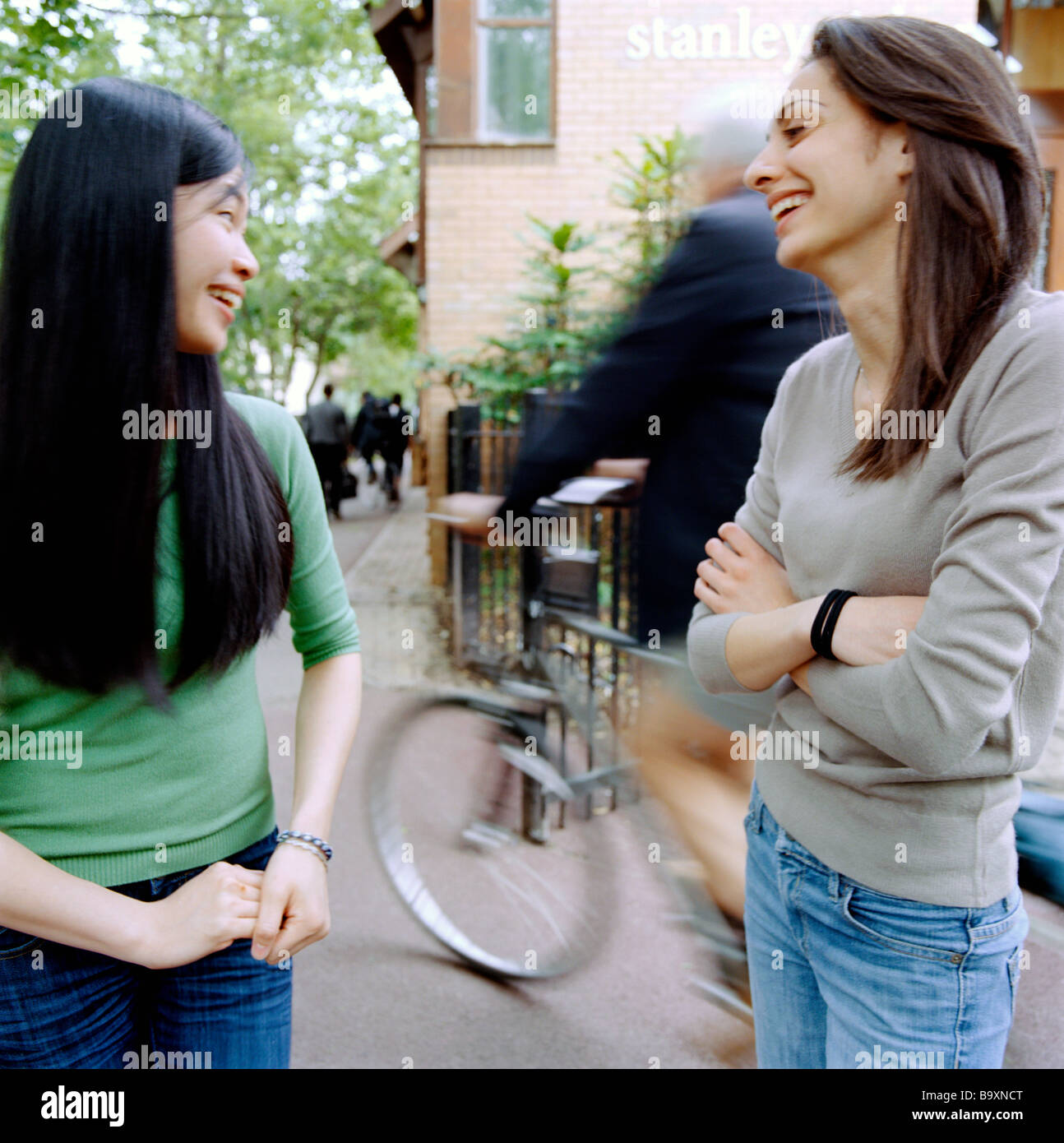 young girls chatting, talking, laughing together while out socializing ...
