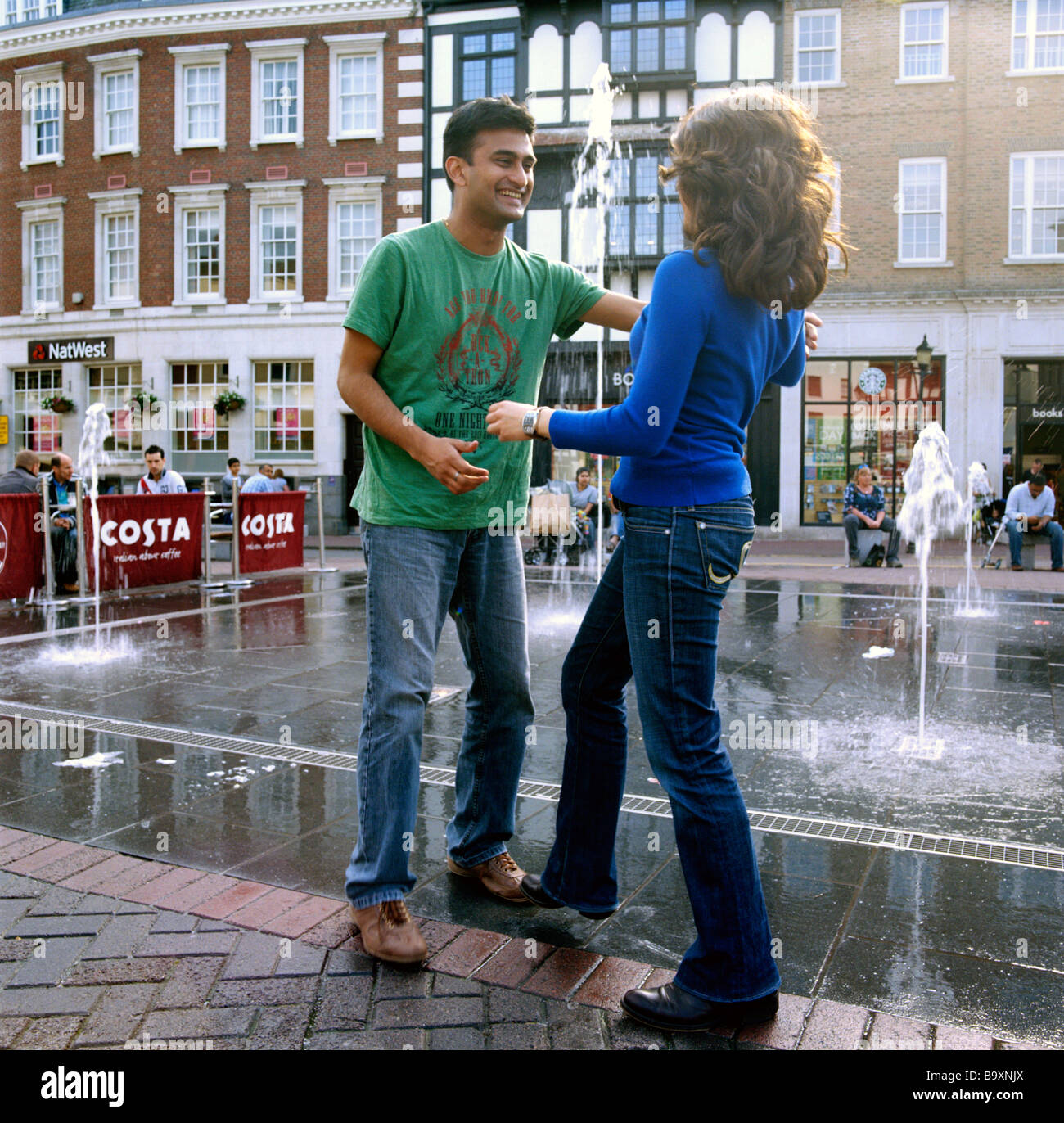 two friends playing, having fun with one another one sunny afternoon in ...