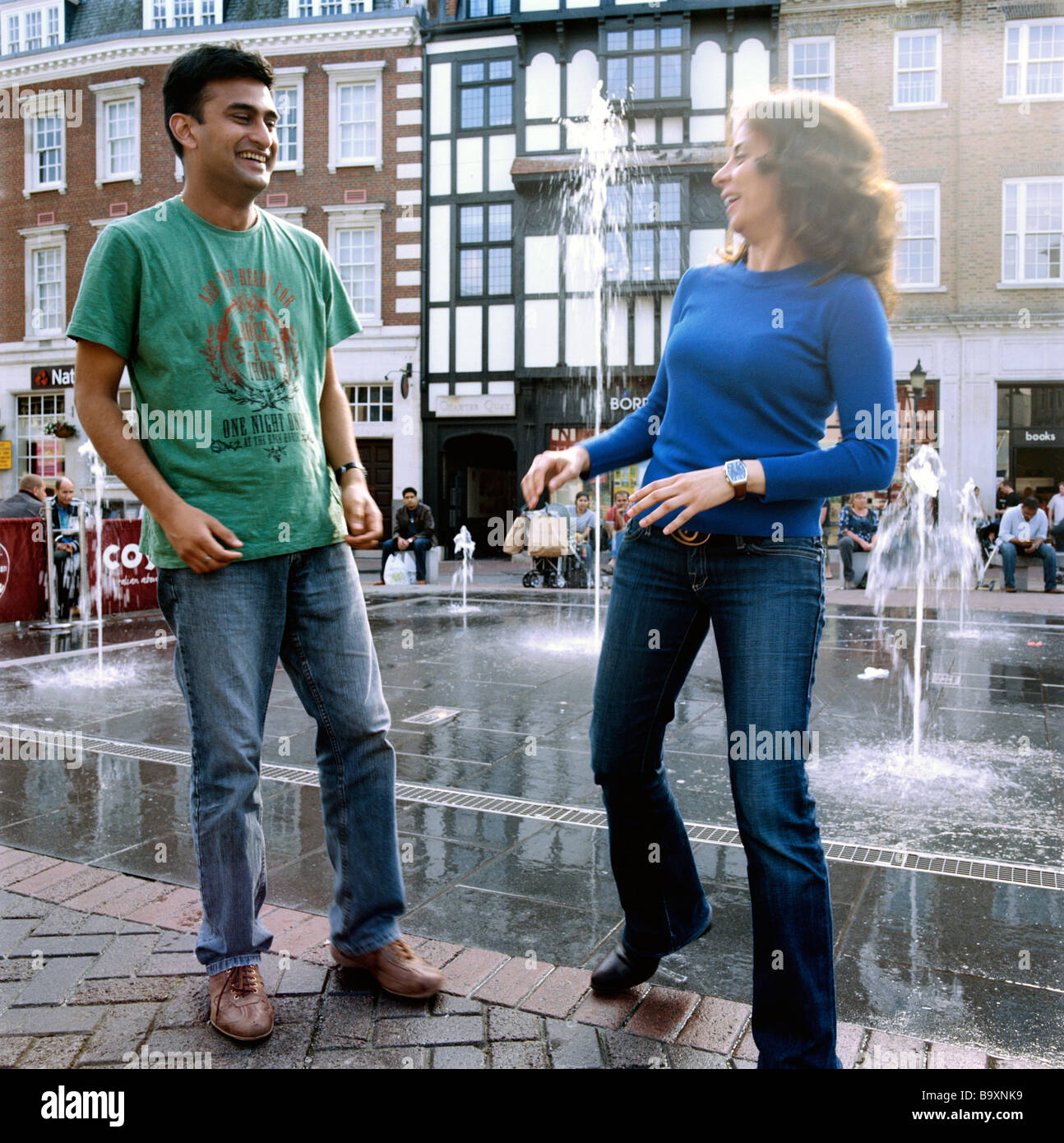 two friends playing, having fun with one another one sunny afternoon in ...