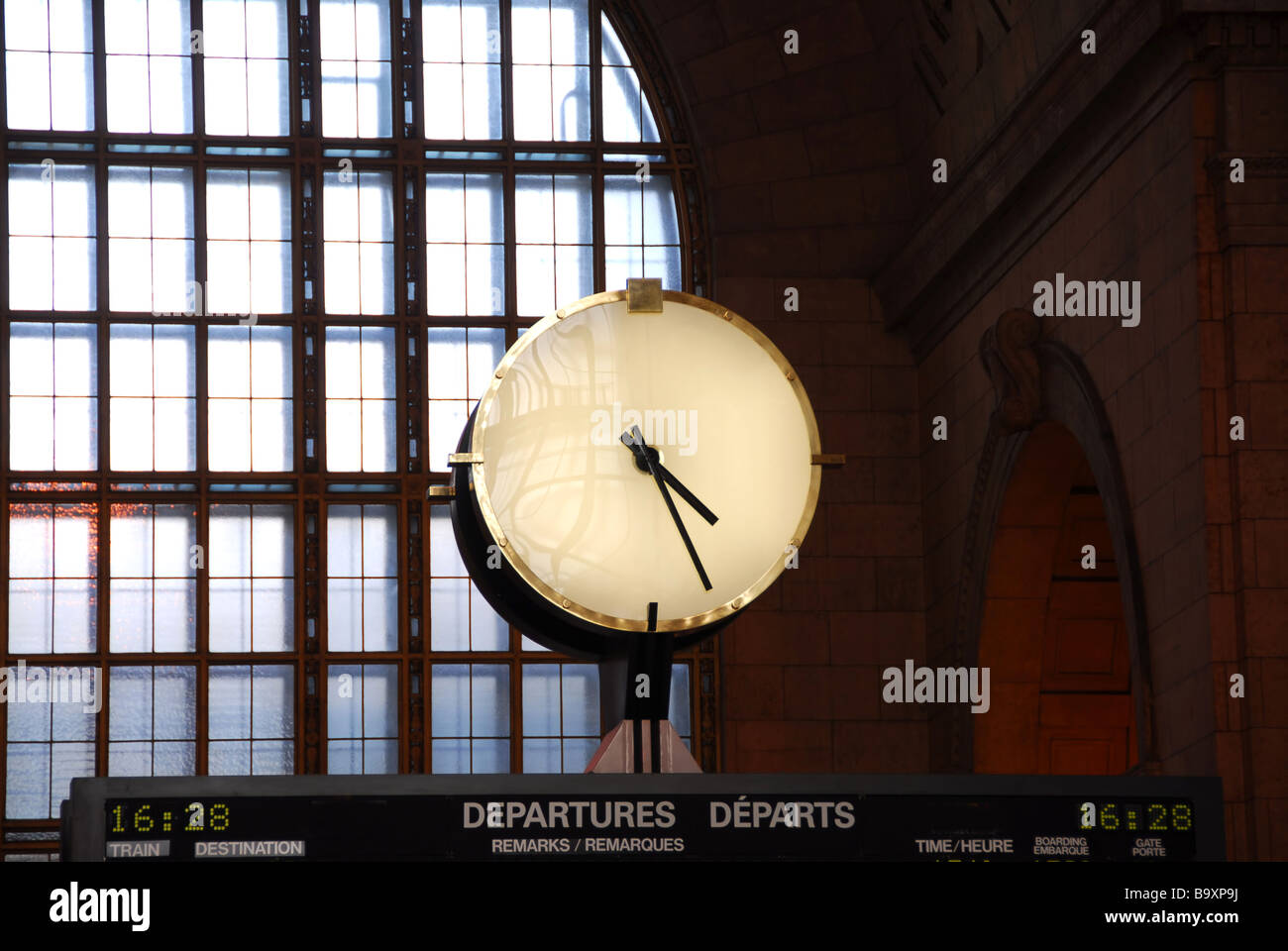 Big clock inside a train station on top of the time table Stock Photo ...