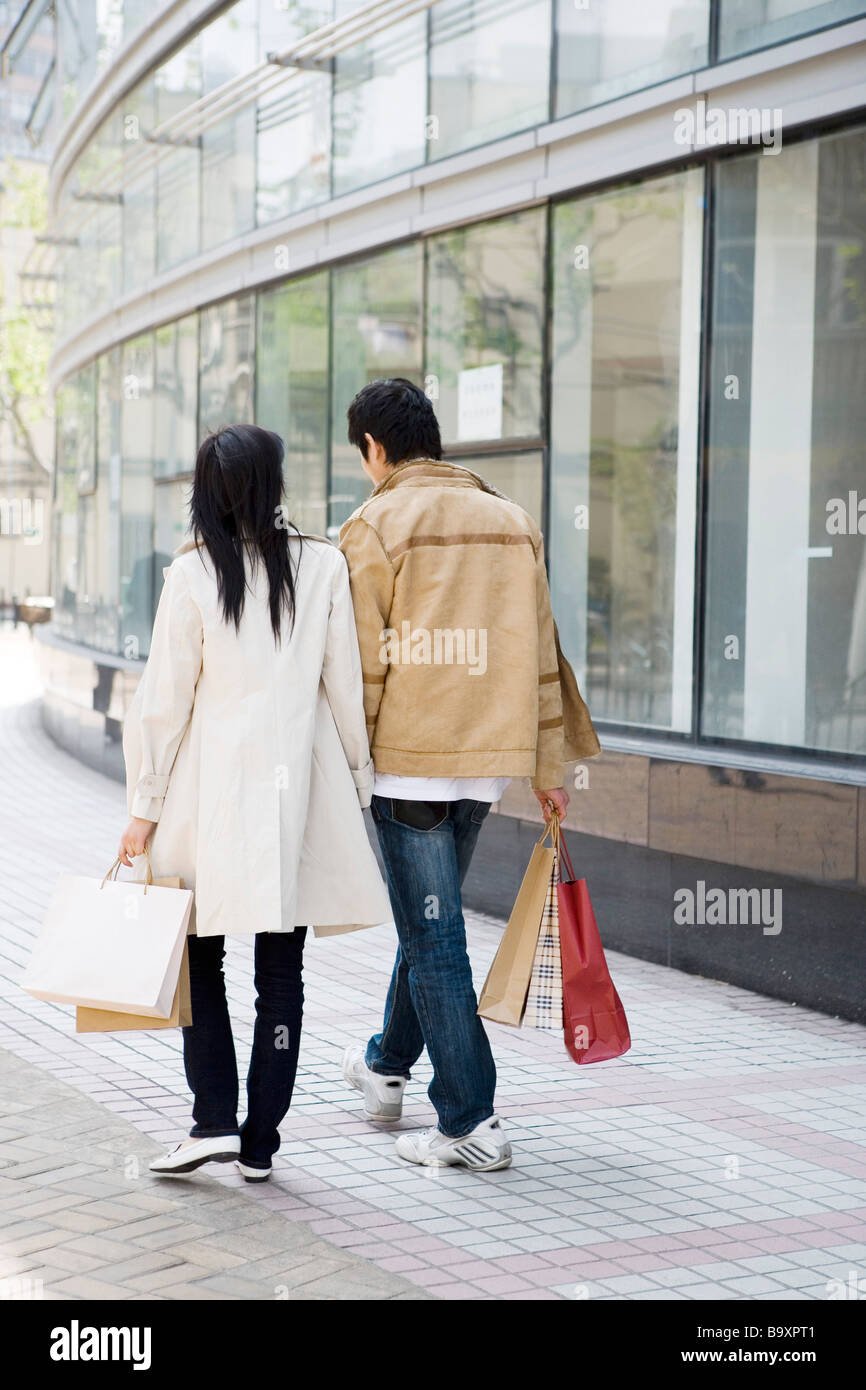Young couple walking on street rear view Stock Photo - Alamy