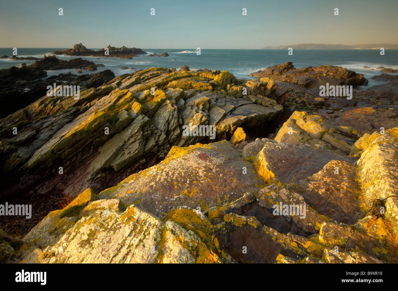 Dawn over Shag stone off Heybrook Bay coastline Devon UK Stock Photo ...