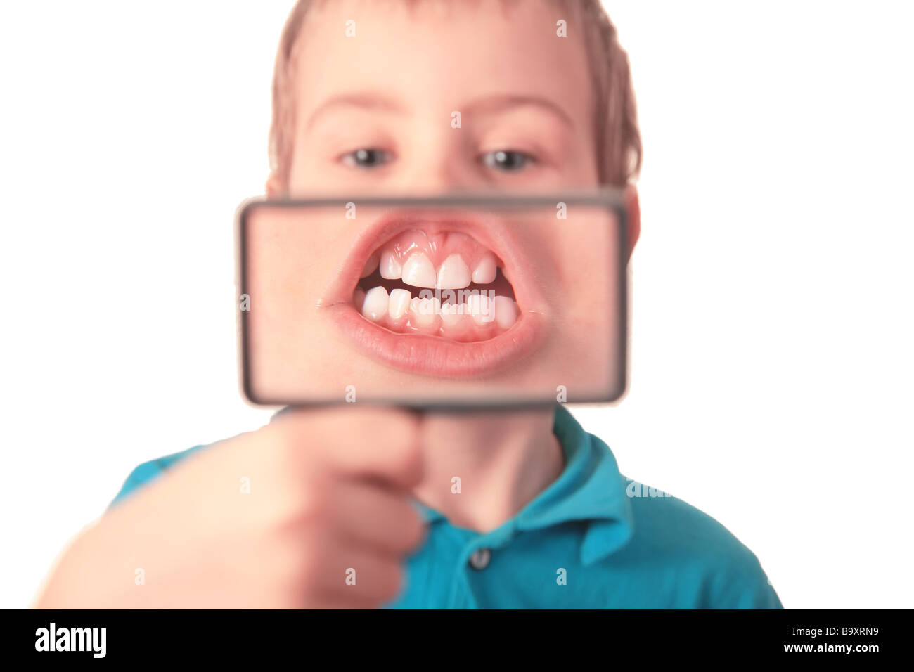 boy shows teeth through magnifier Stock Photo - Alamy