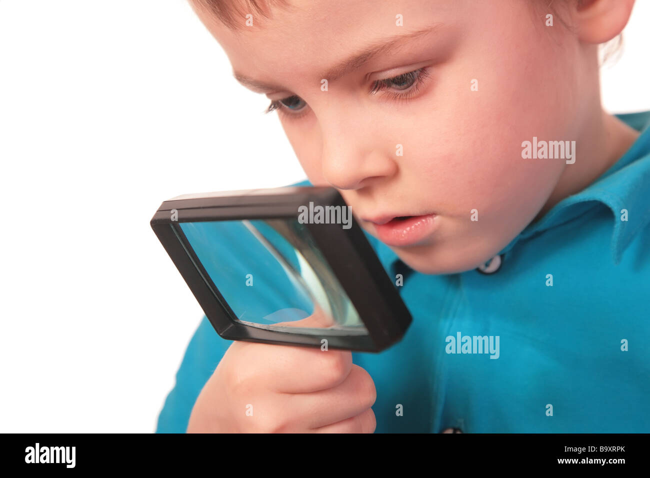 boy looks through magnifier Stock Photo - Alamy