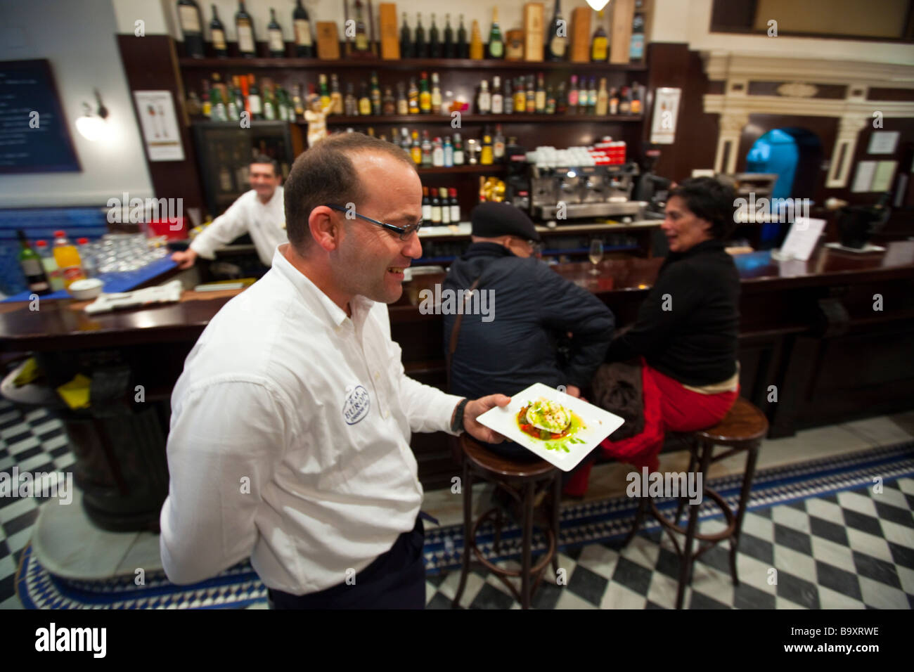 Waiter Delivering Pepper con Queso Tapa at Bar Europa in Seville Spain ...