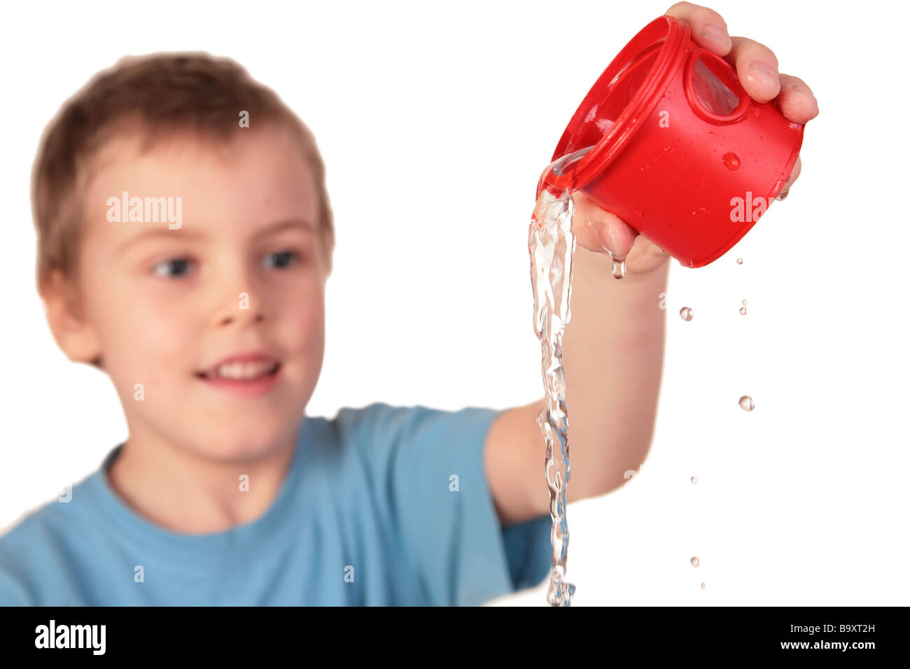boy pours out water from red plastic cup Stock Photo - Alamy