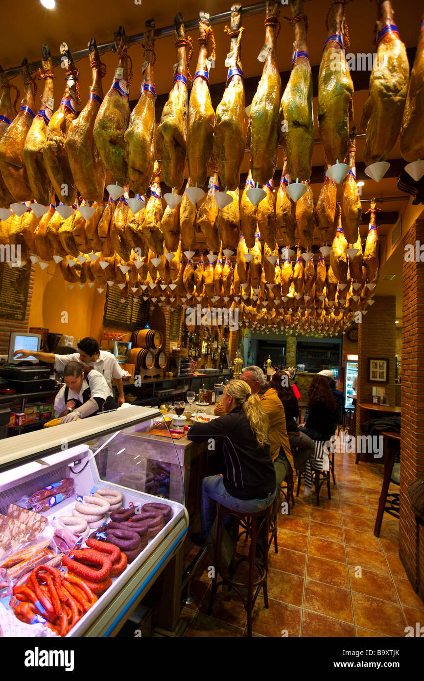Cured ham hanging in restaurant hi-res stock photography and images - Alamy
