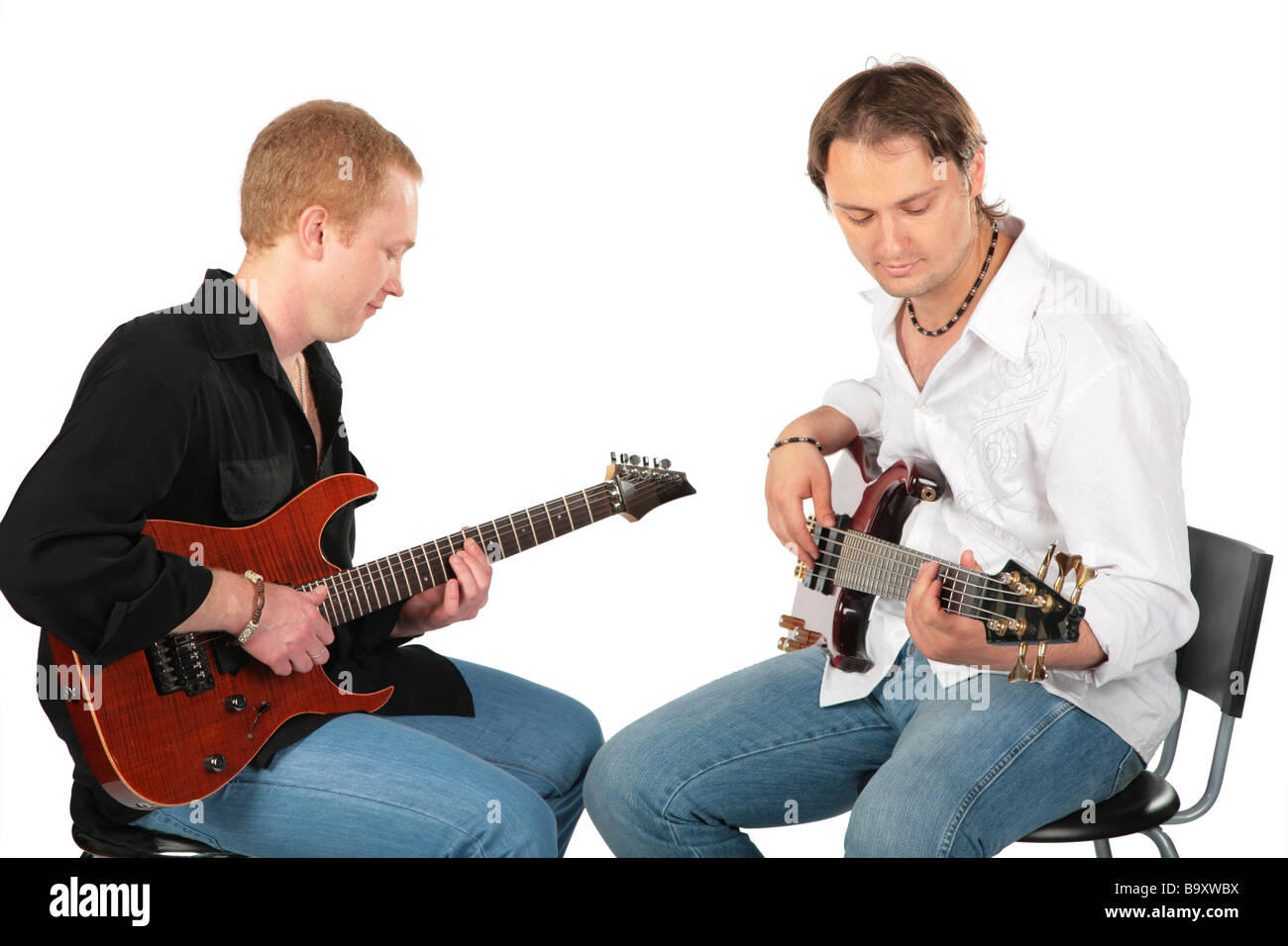 Two sitting men play on guitars Stock Photo - Alamy