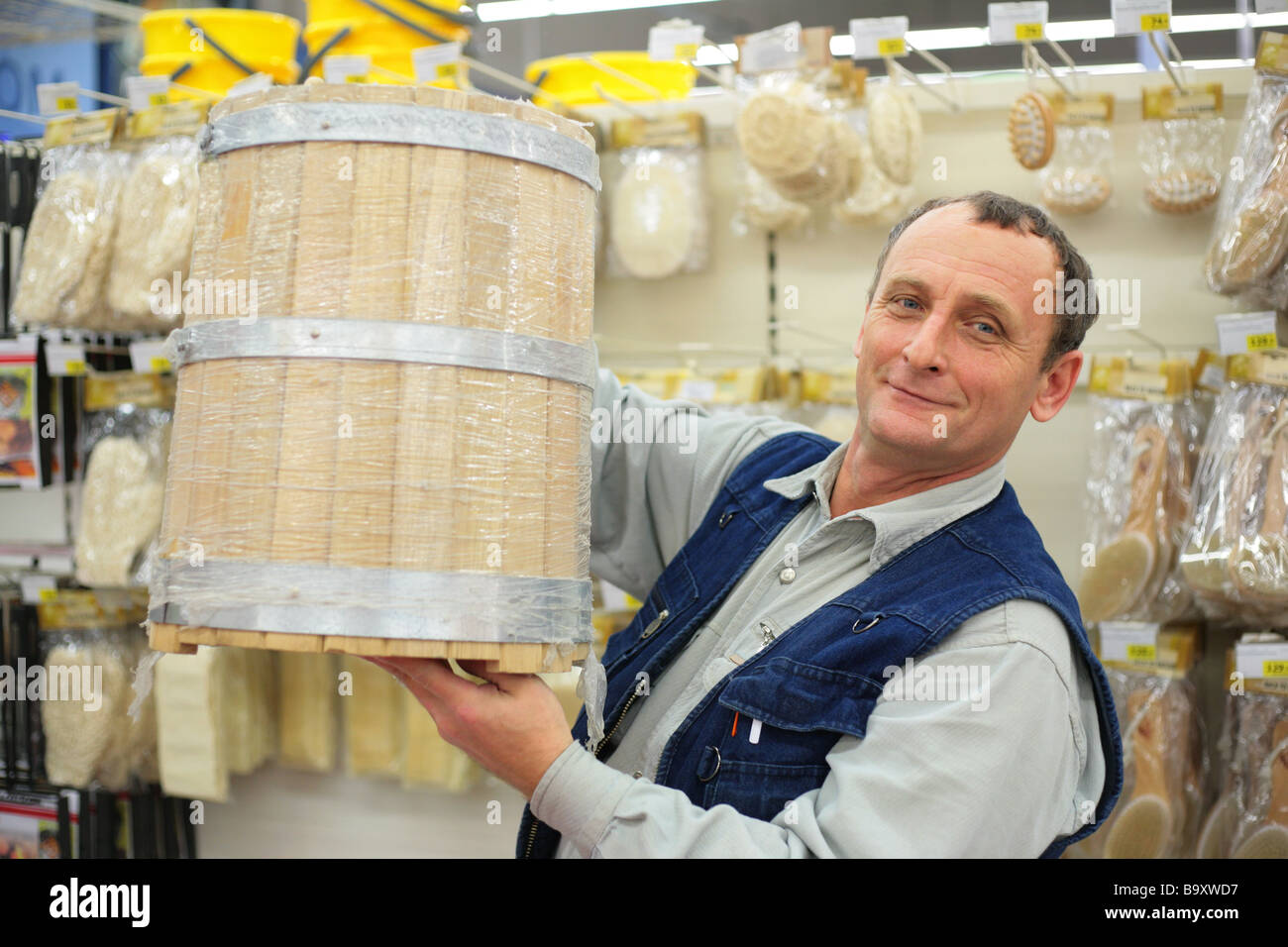 Man with wooden barrel in store Stock Photo - Alamy