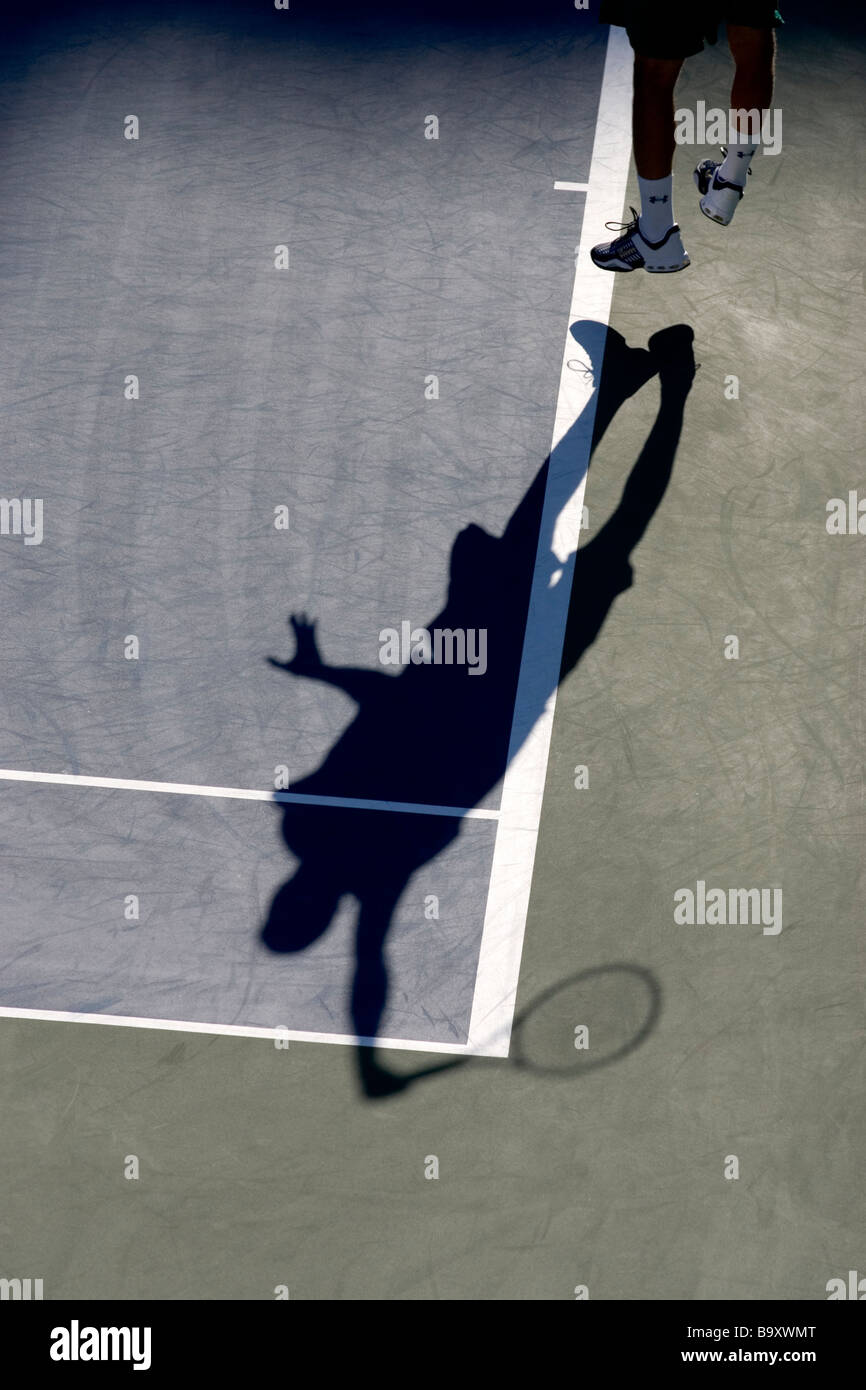 Shadow of tennis player serving Stock Photo - Alamy