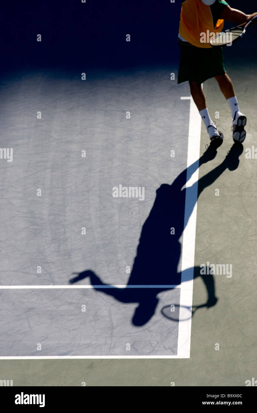 Shadow of tennis player serving Stock Photo - Alamy