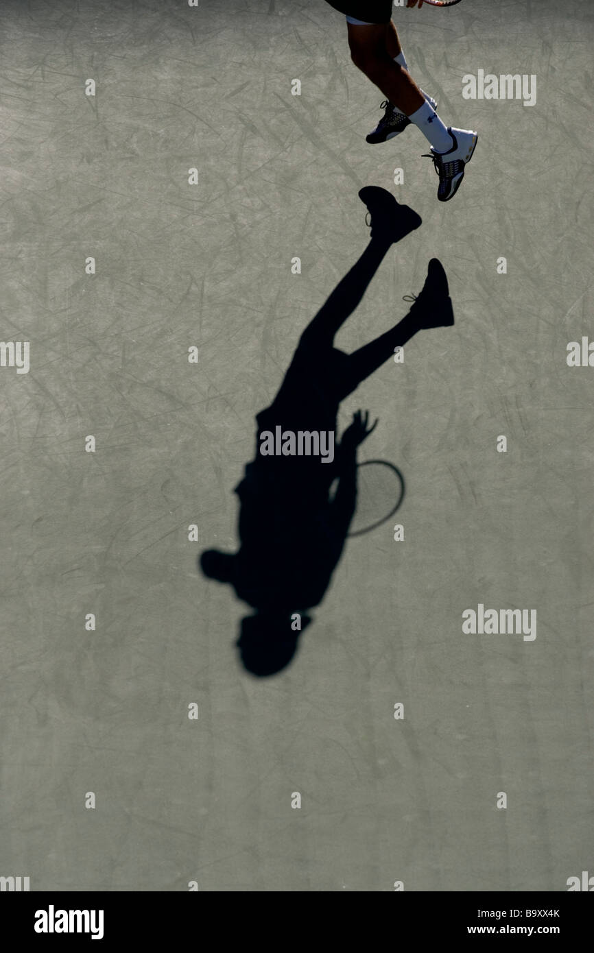 Shadow of tennis player serving Stock Photo - Alamy