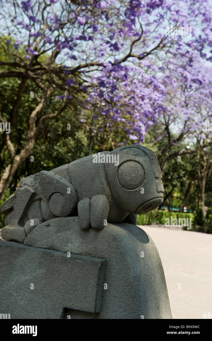 A stone locust, with jacaranda tree behind, at the National Museum of ...