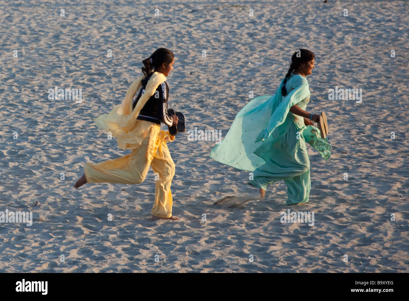 Indian Girls Running in the Sand Across from the Taj Mahal in Agra ...