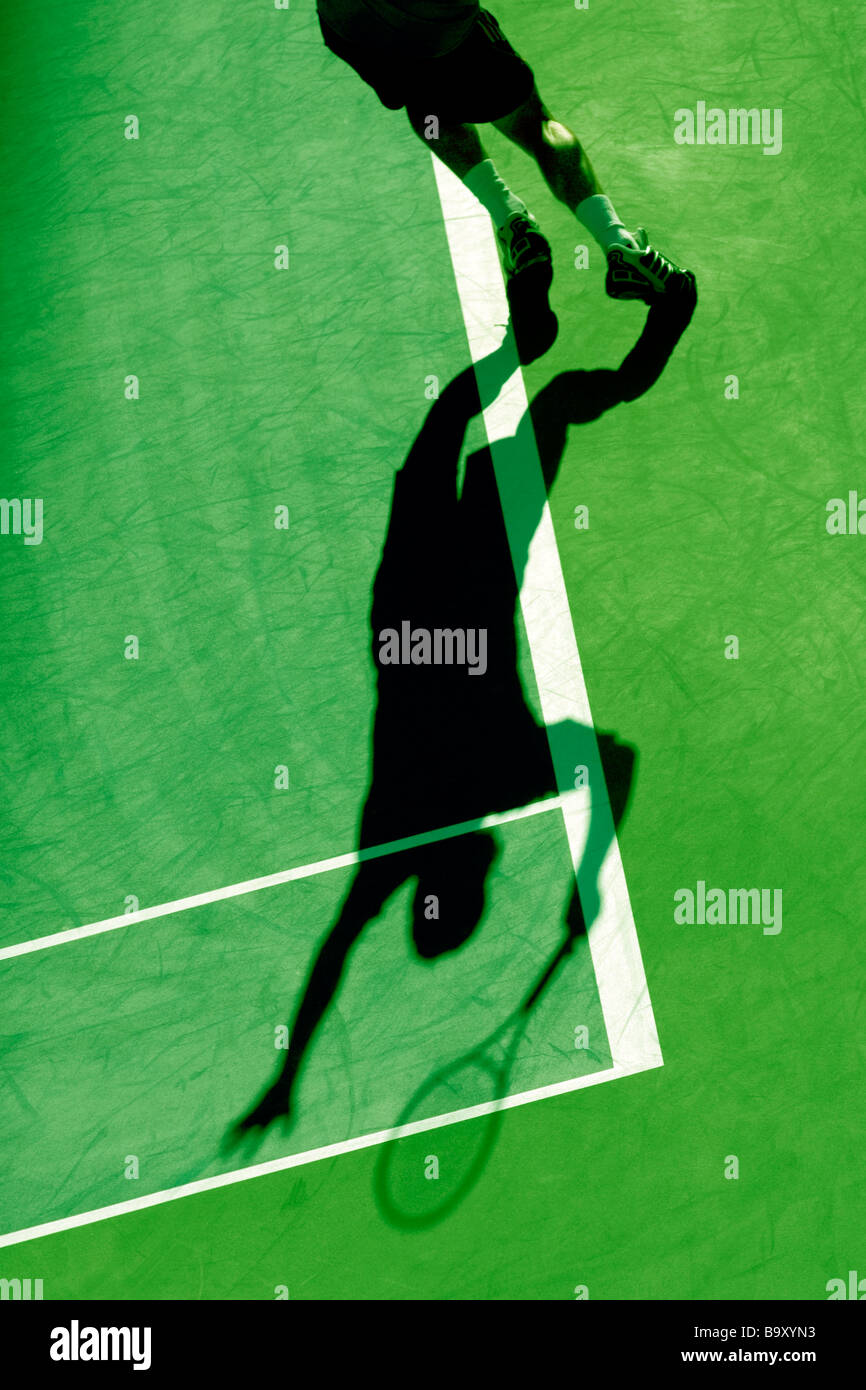 Shadow of tennis player serving Stock Photo - Alamy