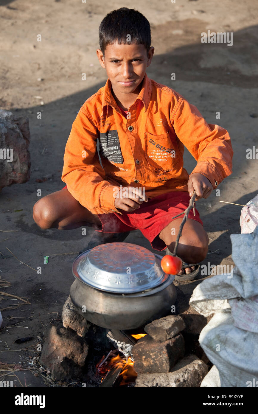 Boy Cooking Over an Open Fire in Delhi India Stock Photo - Alamy