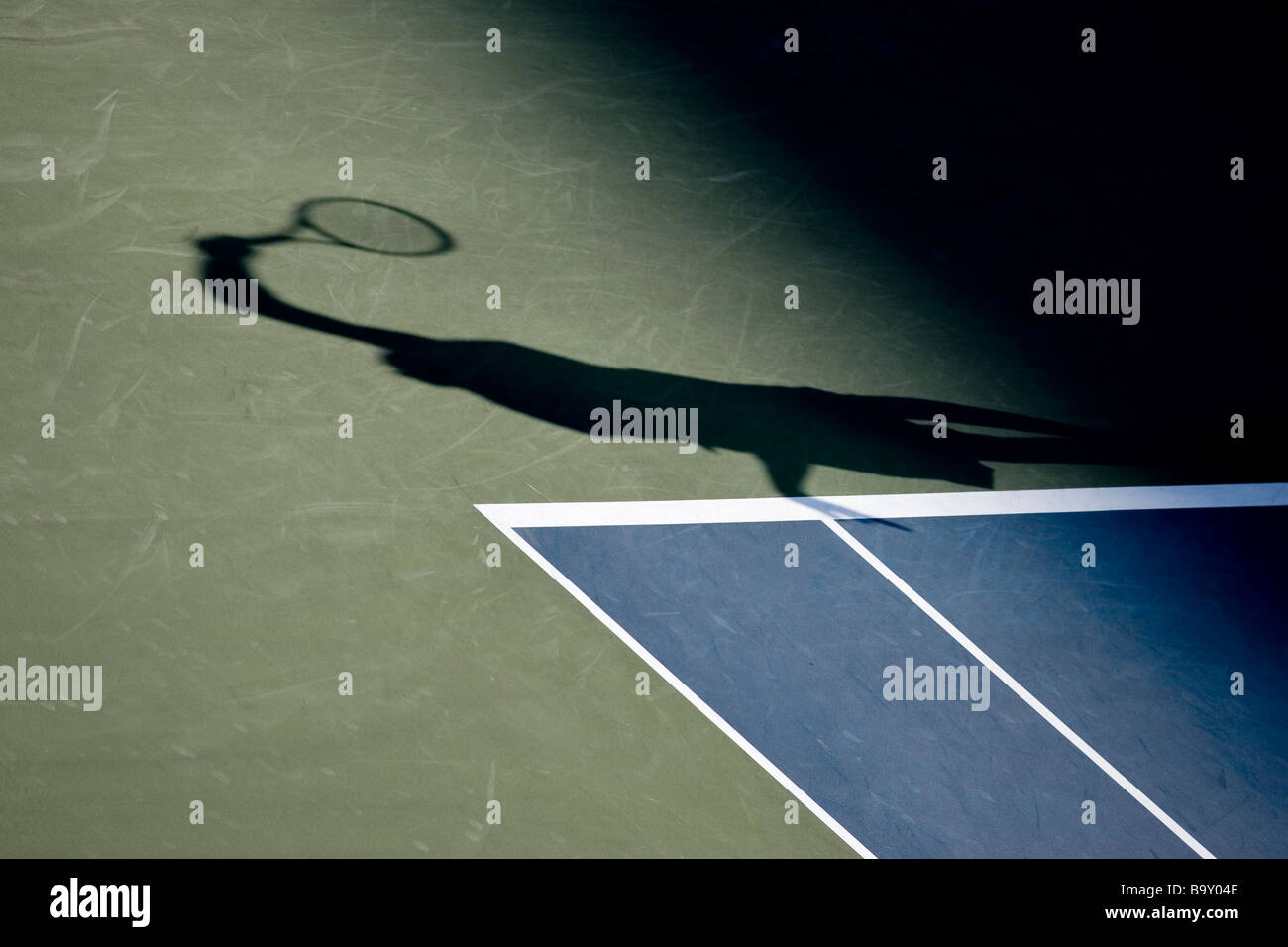 Shadow of tennis player serving Stock Photo - Alamy
