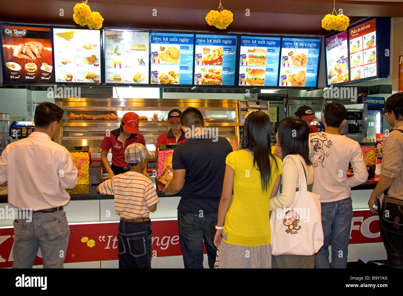Vietnamese people eat at a KFC restaurant inside the Diamond Plaza ...