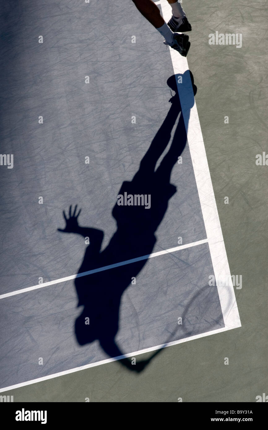 Shadow of tennis player serving Stock Photo - Alamy
