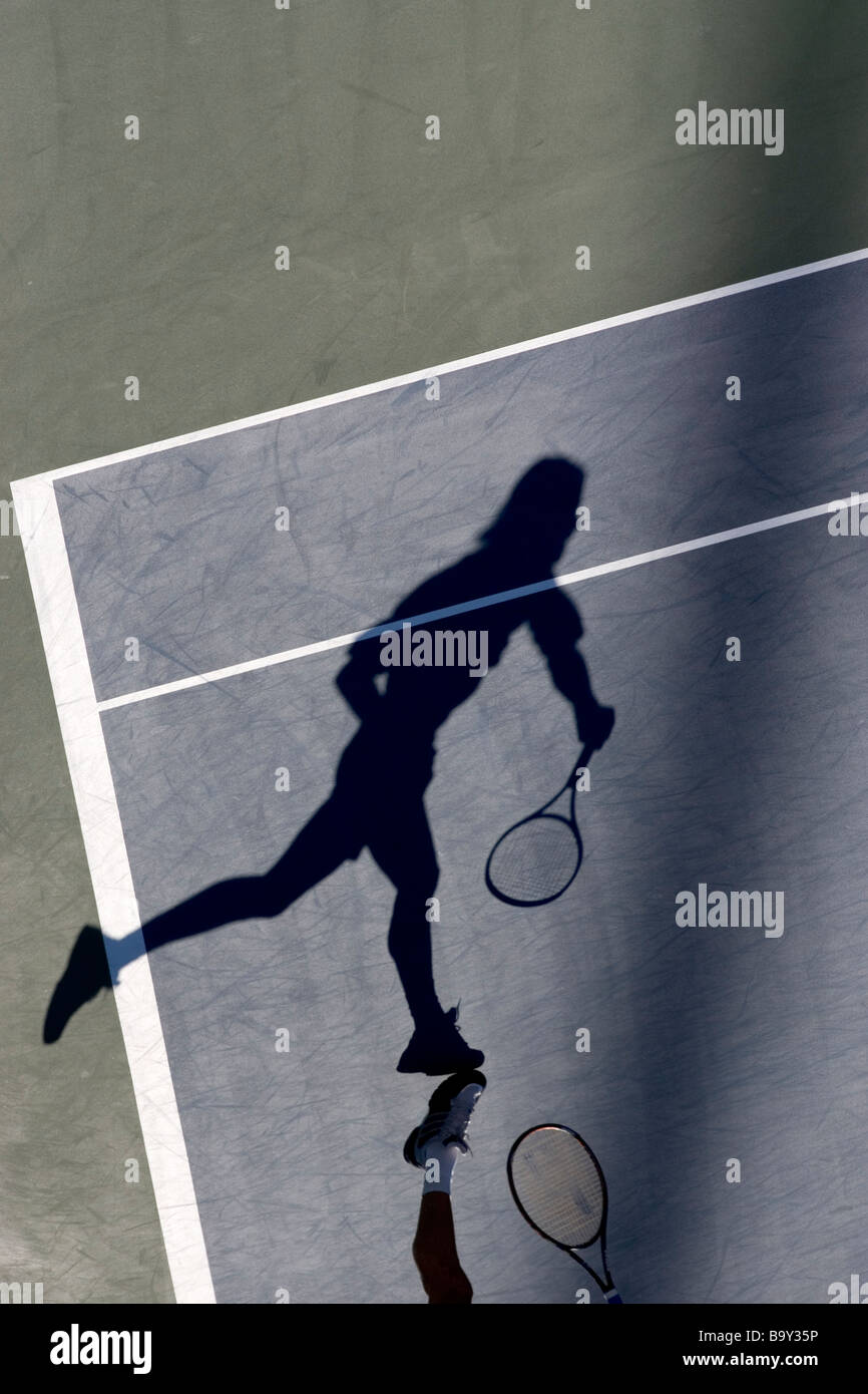 Shadow of tennis player serving Stock Photo - Alamy