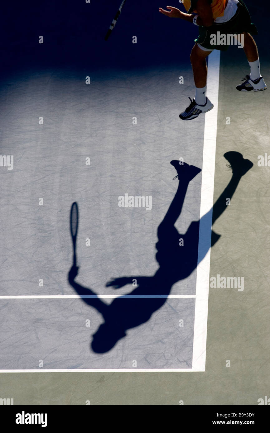 Shadow of tennis player serving Stock Photo - Alamy