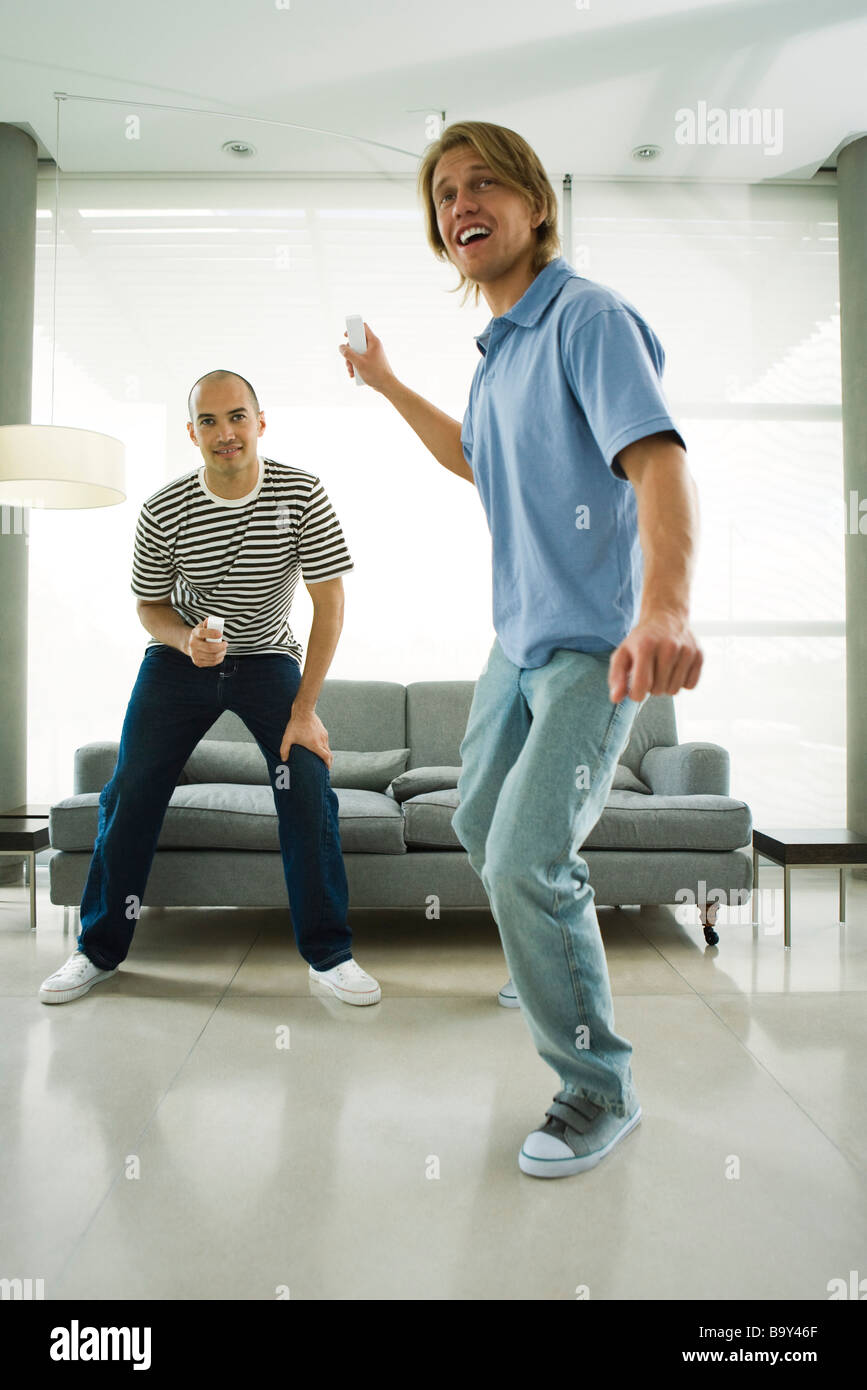 Two men playing video games with wireless controllers Stock Photo - Alamy