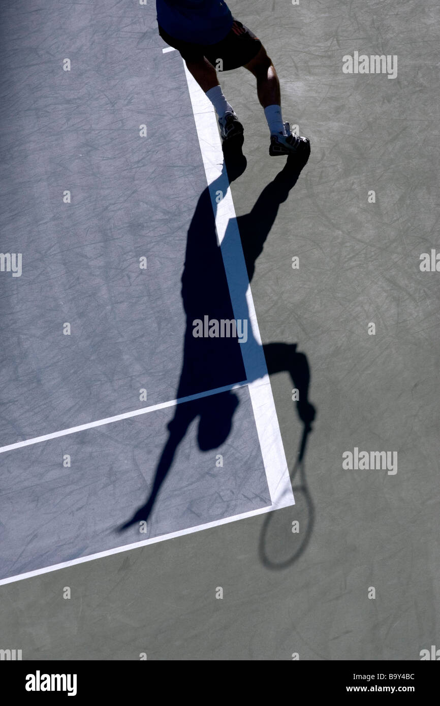 Shadow of tennis player serving Stock Photo - Alamy