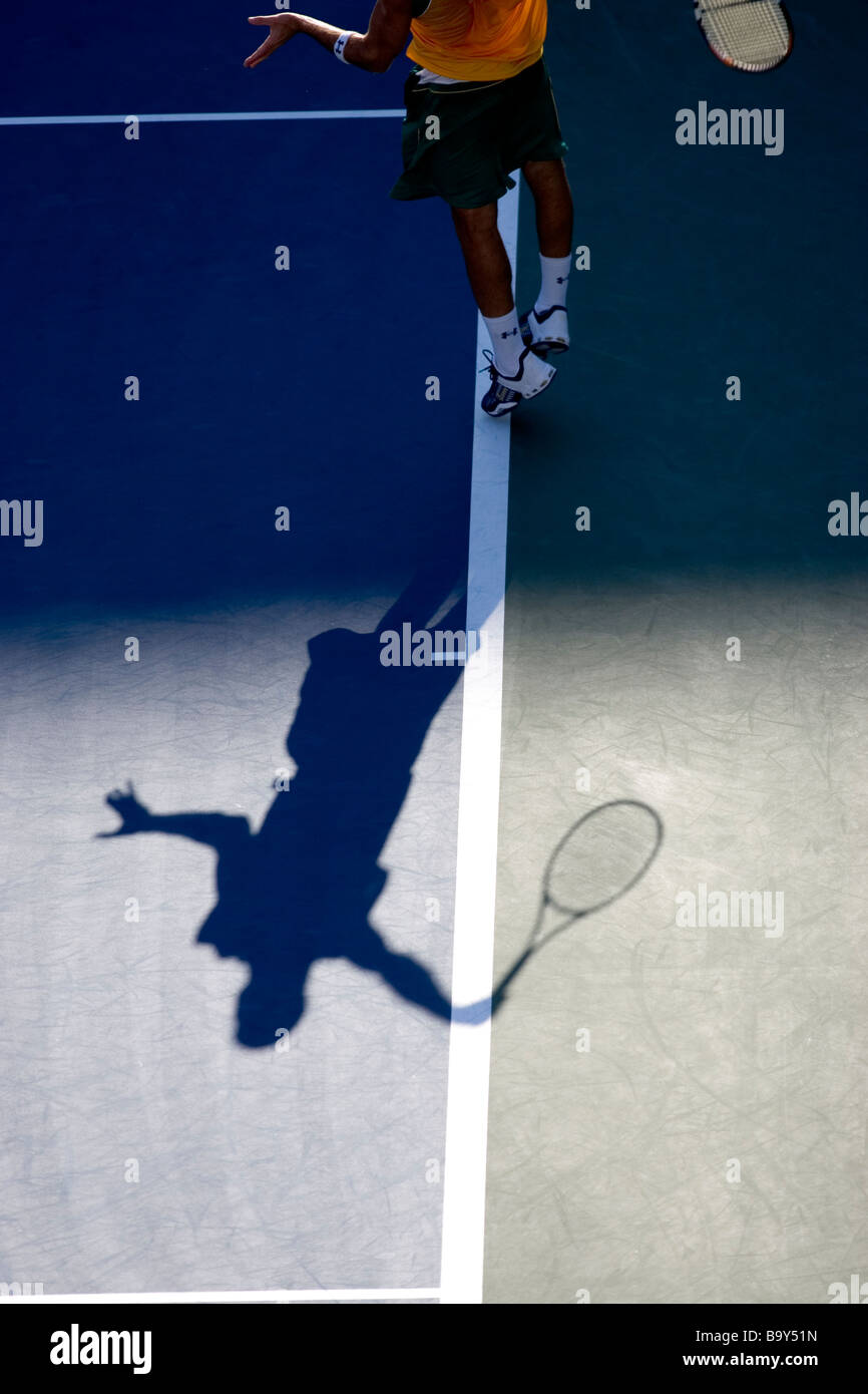 Shadow of tennis player serving Stock Photo - Alamy