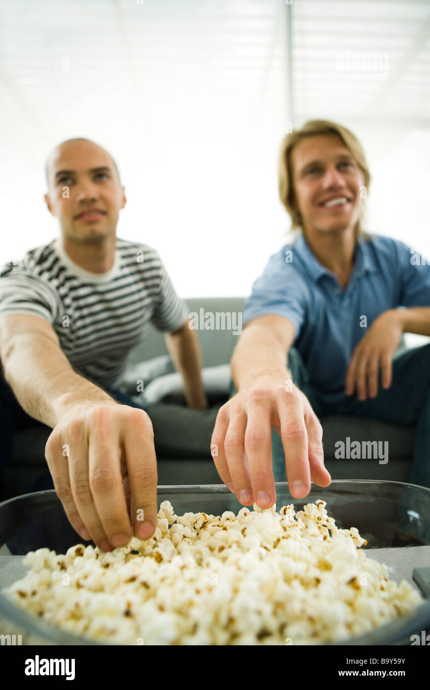 Two men eating popcorn lounge hi-res stock photography and images - Alamy