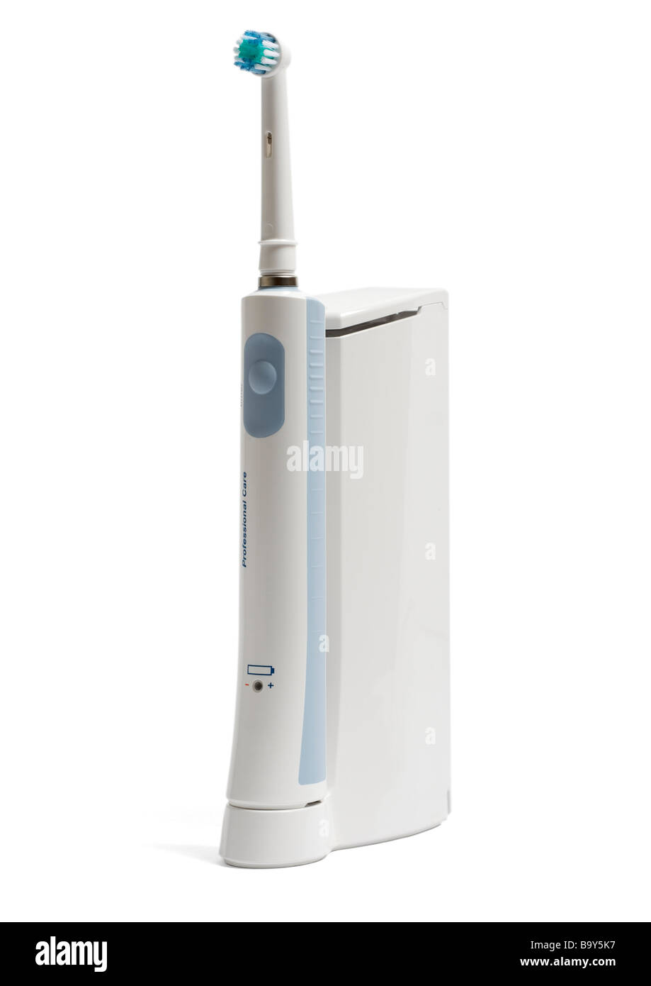 Electric toothbrush and cradle on white background Stock Photo - Alamy